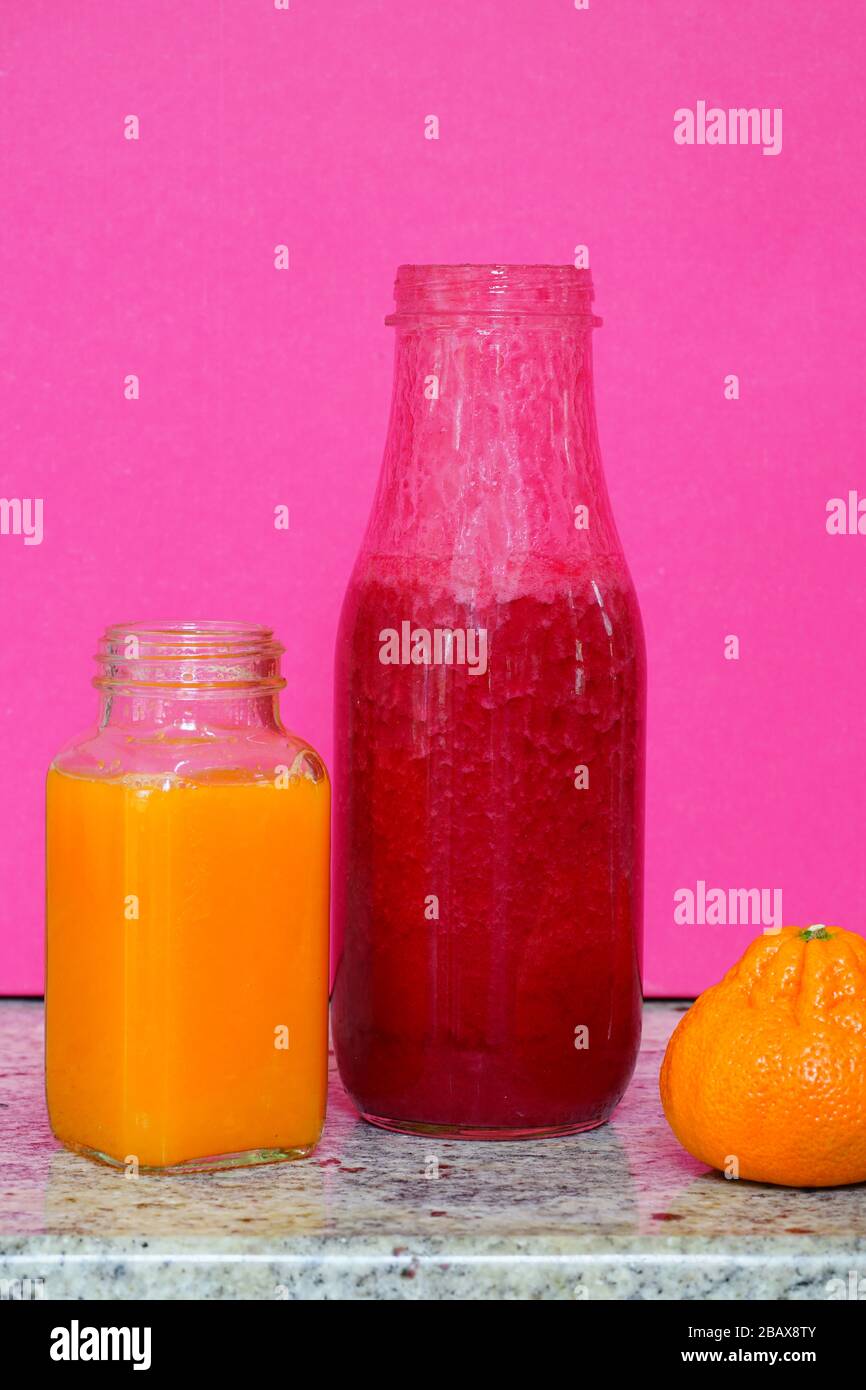 Glass bottles filled with colorful homemade beet smoothies Stock Photo ...
