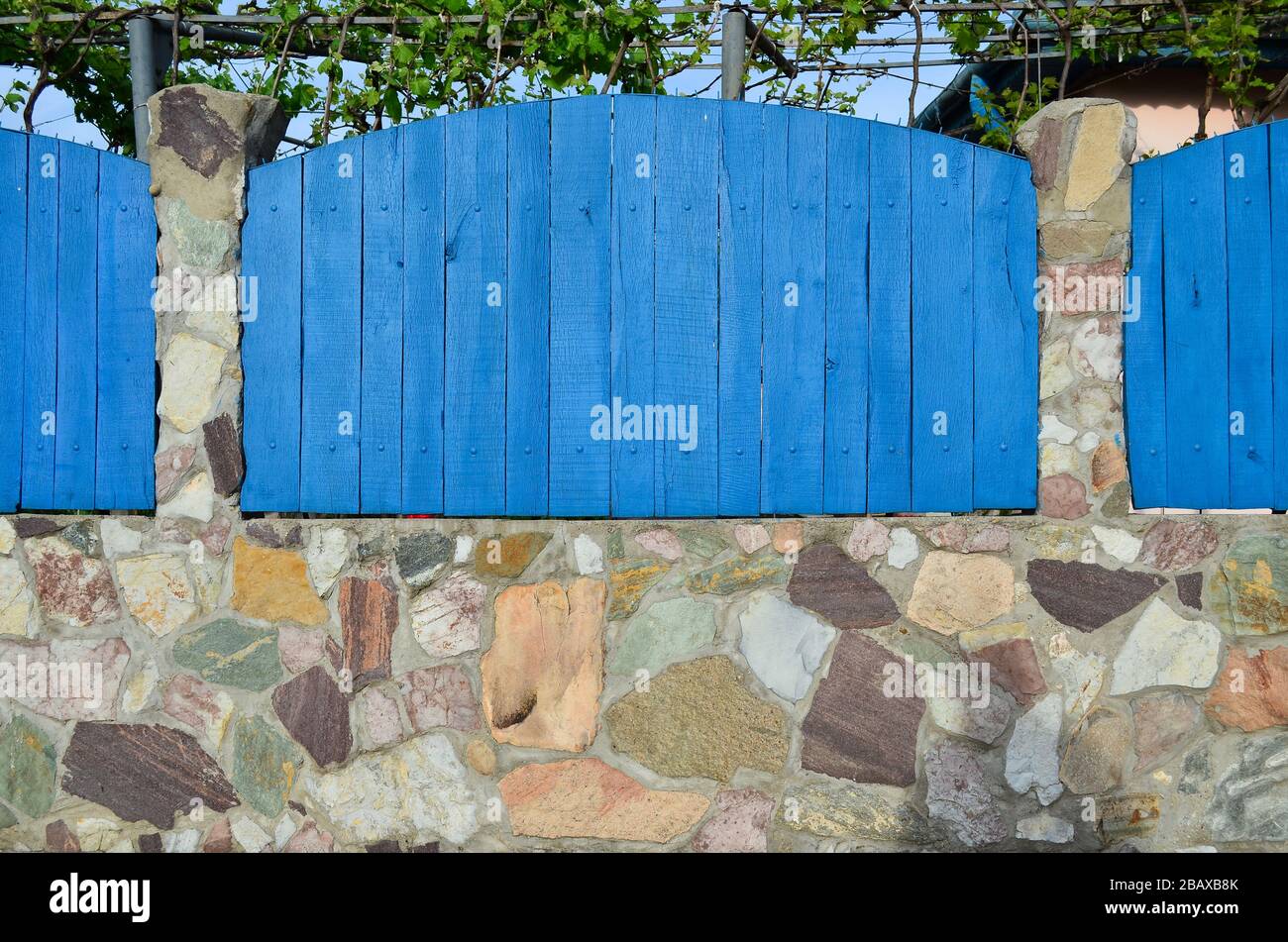 Blue wooden and stone fence, built in traditional Romanian way Stock ...