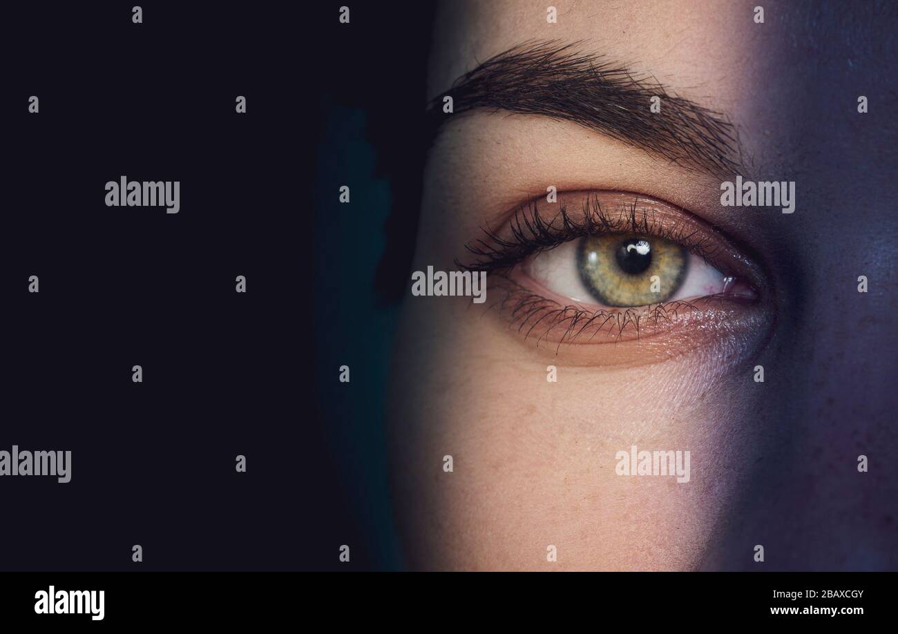 eyes spying concept through hole against dark background Stock Photo ...