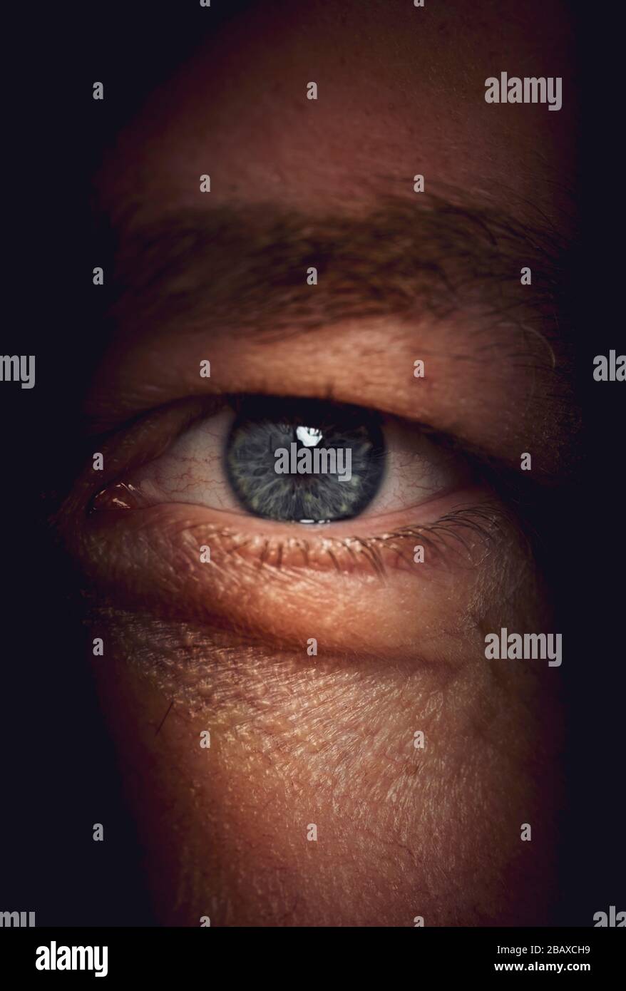 eyes spying concept through hole against dark background Stock Photo ...