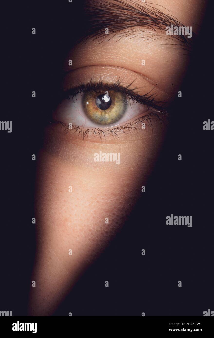 eyes spying concept through hole against dark background Stock Photo ...