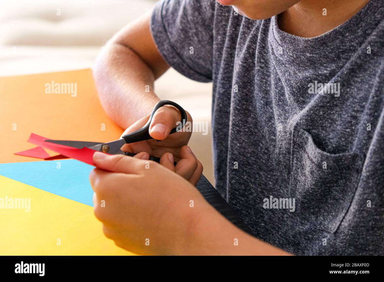 Paper crafts for kids. Child hands cutting colored paper with scissors ...