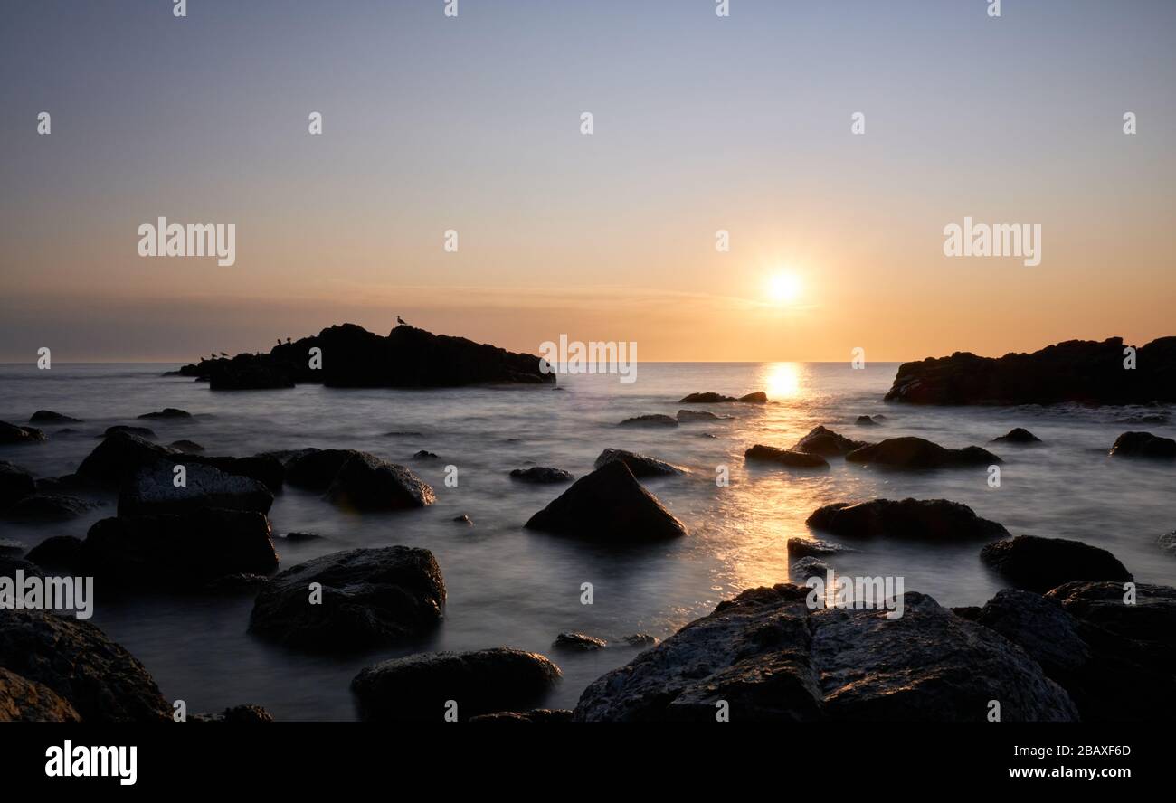 View of the sun burst or the star sun over the rock with the sunset at ...