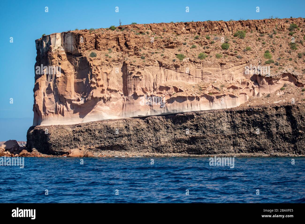 The rocks forming a small mountain with different layers of sediments ...