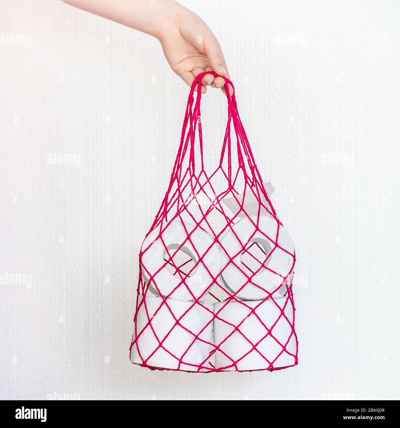 Red string bag with rolls of toilet paper. Concept of problem with ...