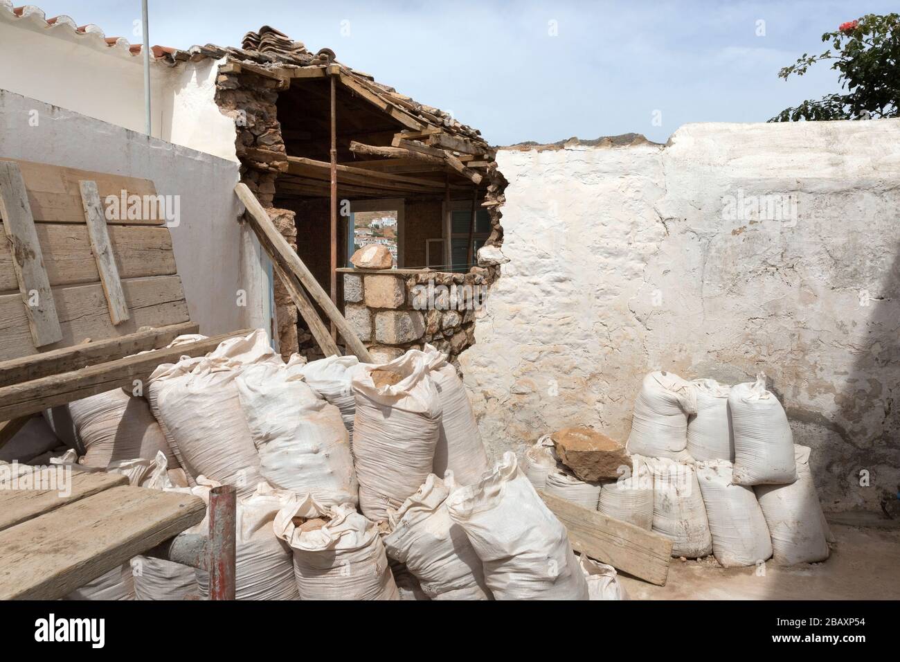 Construction site rebuilding masonry stone walls on the Greek island of ...