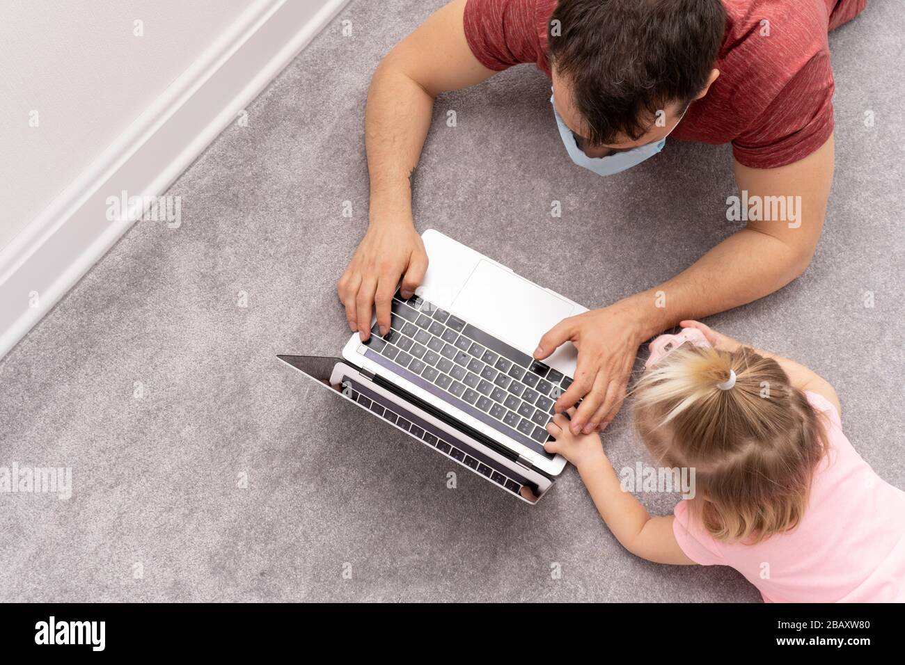 Kid stops father from working Stock Photo - Alamy