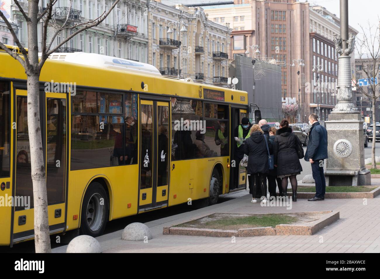Kiev, Ukraine, 27 March 2020, people at the street in protective facial ...