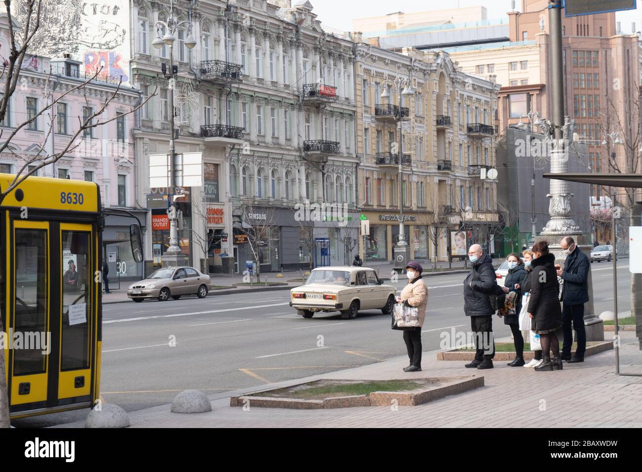 Kiev, Ukraine, 27 March 2020, people at the street in protective facial ...