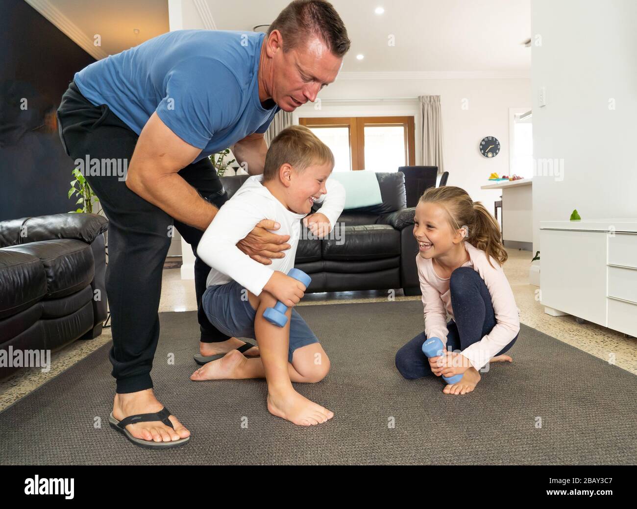 Family exercising together during COVID-19 lockdown. Father and ...