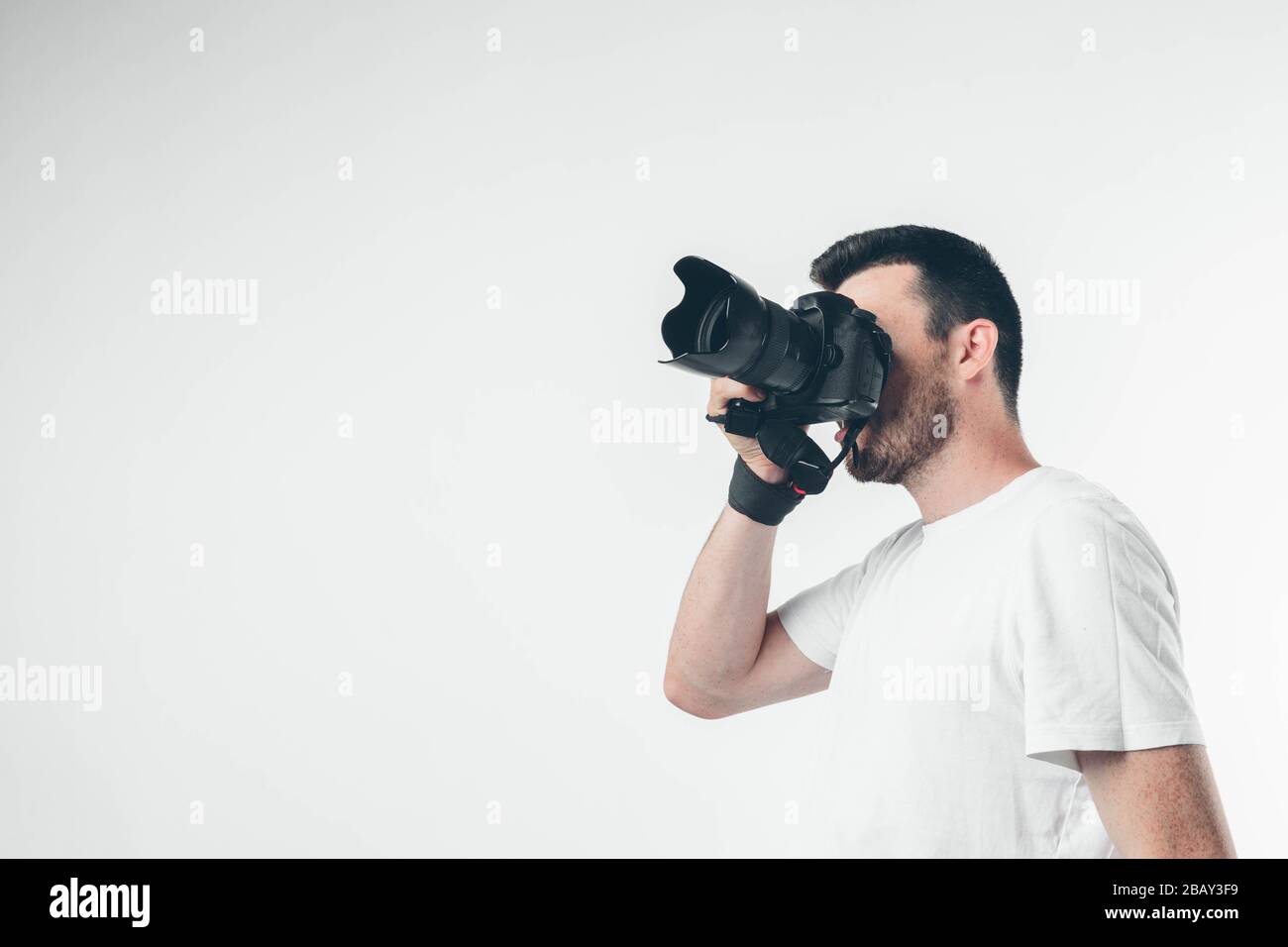 Side view of photographer isolated over white background taking ...