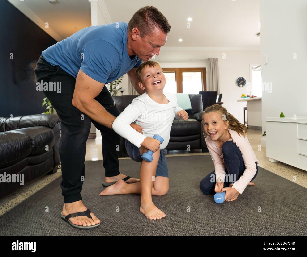 Family exercising together during COVID-19 lockdown. Father and ...