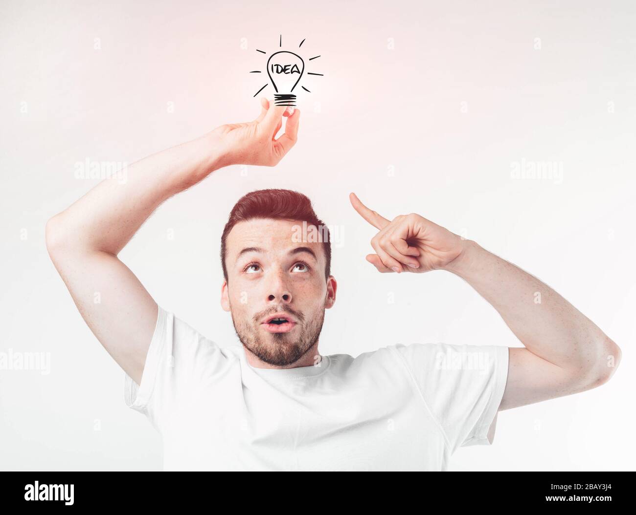 Portrait of young genious man holding lamp. Guy with an idea - isolated ...