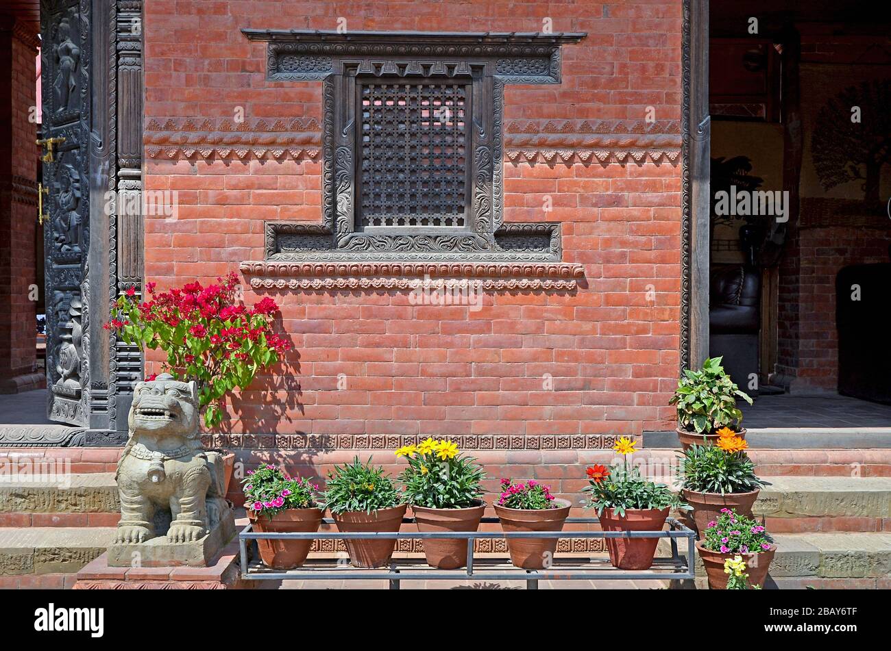 Beautiful wooden window in Nepal with colorful plants in front of it ...