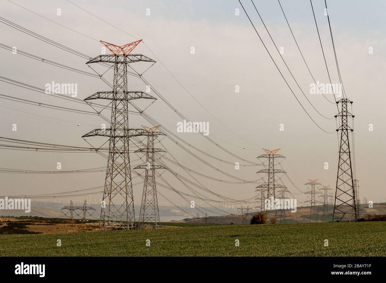 Electricity pylons at sunset, power transmission lines Stock Photo - Alamy