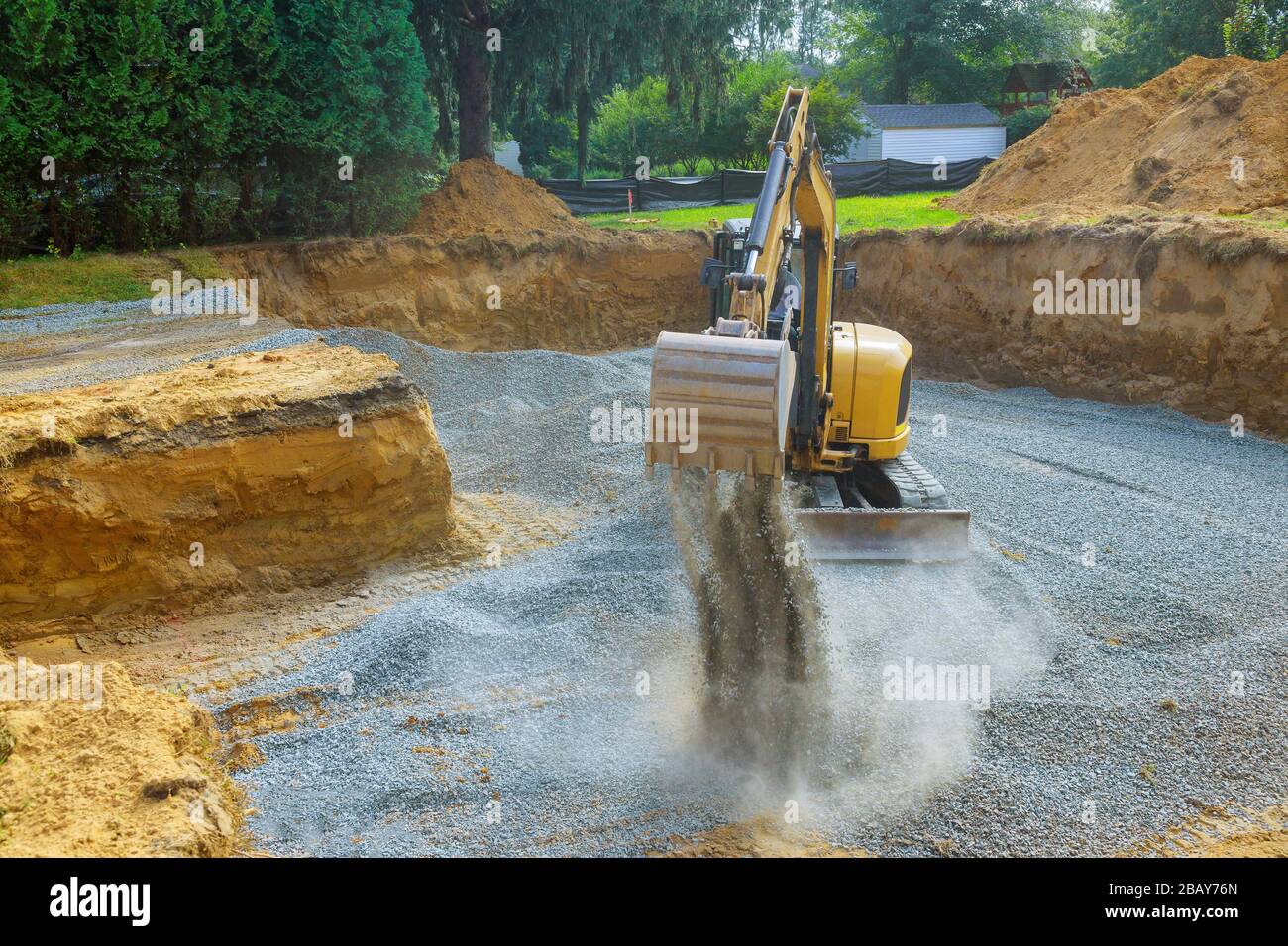 Excavator digging bucket scooping gravel from in the building ...