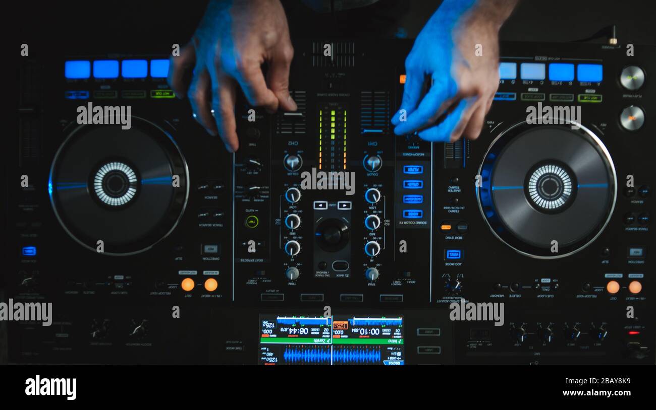 High angle closeup of a DJ working under the lights in a studio Stock ...