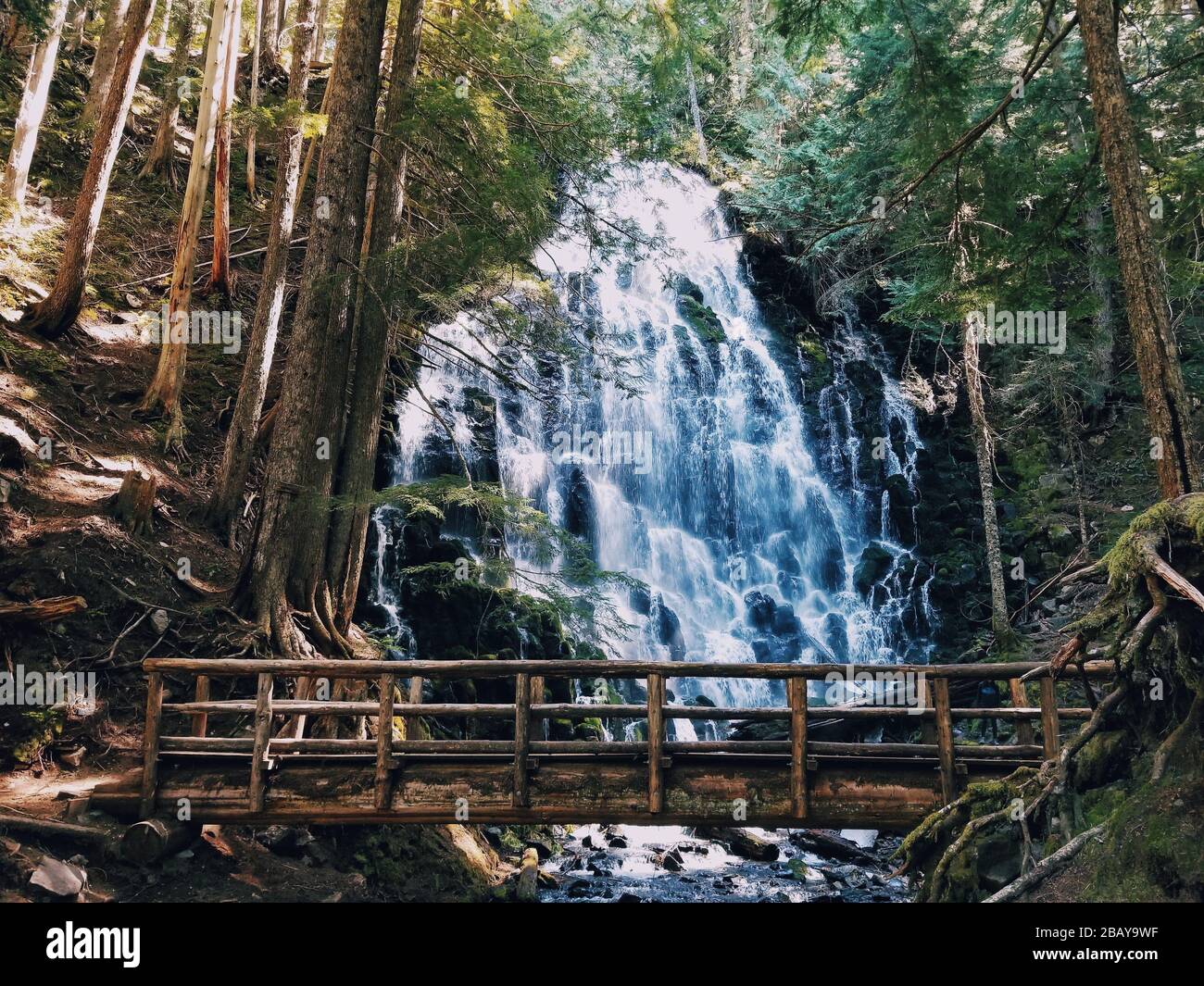Beautiful waterfall and a wooden small bridge Stock Photo - Alamy