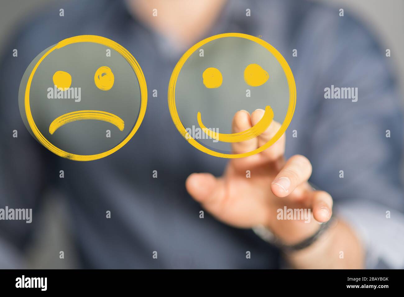 A Hand is selecting a happy mood smiley. In front of an empty room ...