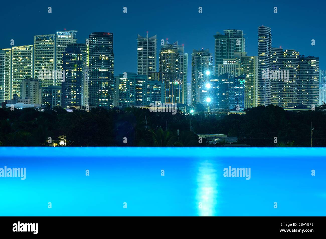 View of the night city of Manila from the pool of the luxury five-star ...