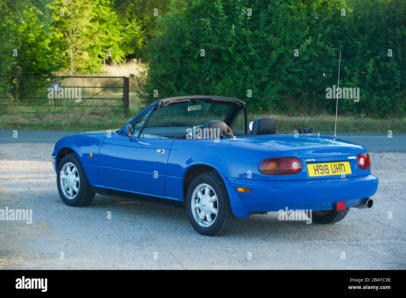 Blue Mazda MX-5 mk1, rear three-quarter angle, in countryside Stock Photo - Alamy