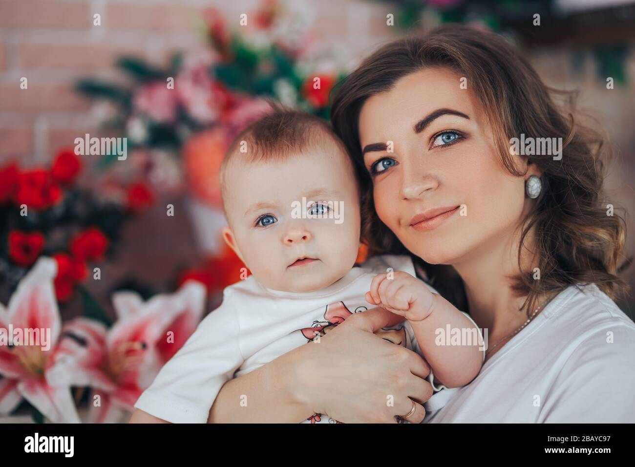 Mother's day. Young beautiful mother hugging with her little baby Stock Photo - Alamy