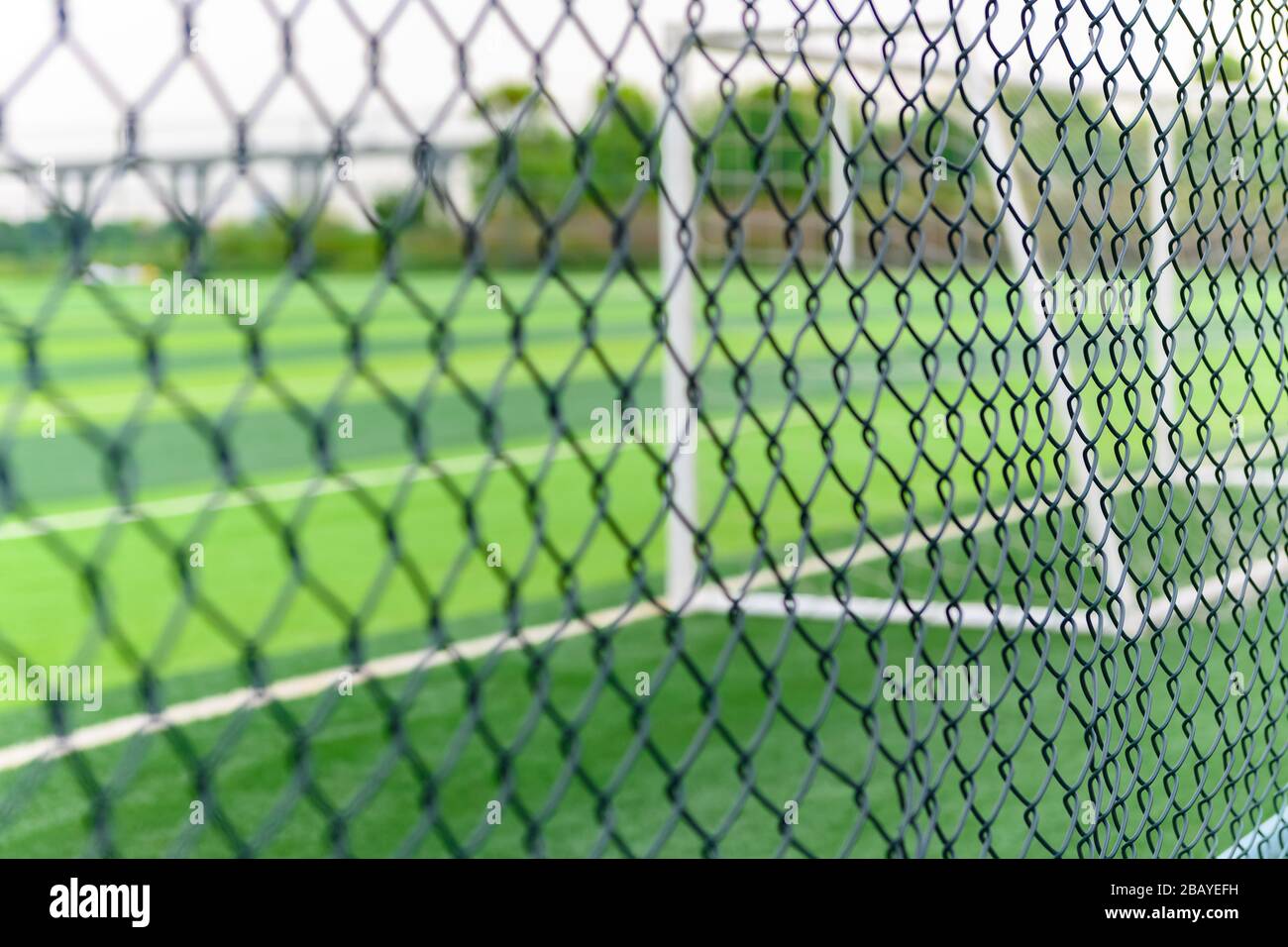 a soccer field behind the fence Stock Photo - Alamy