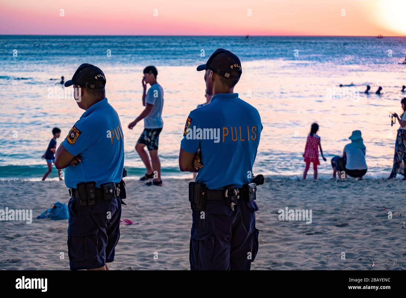 Police officers on the island of Boracay observe order on the beach ...