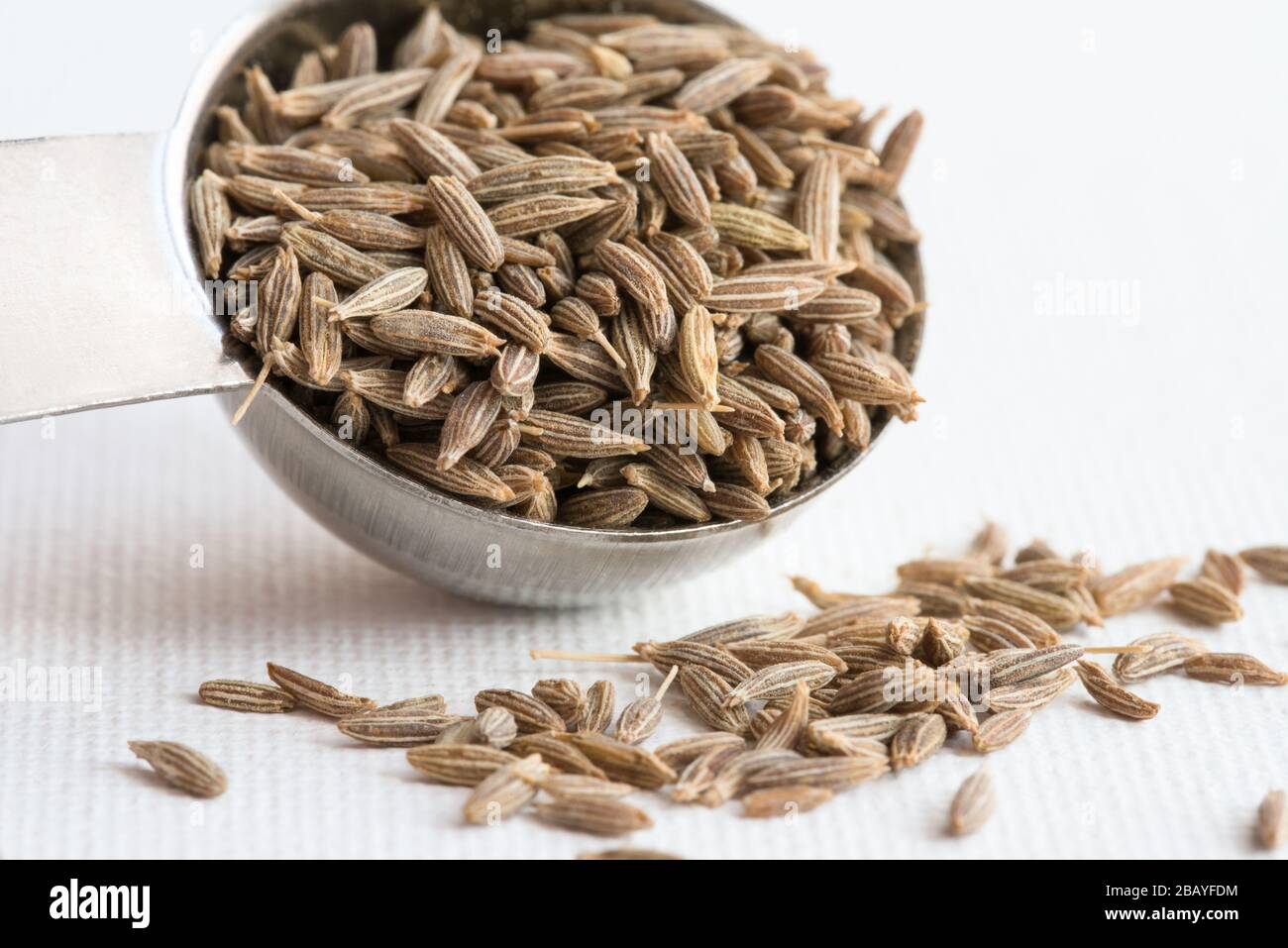 Cumin Seeds Spilled from a Teaspoon Stock Photo - Alamy