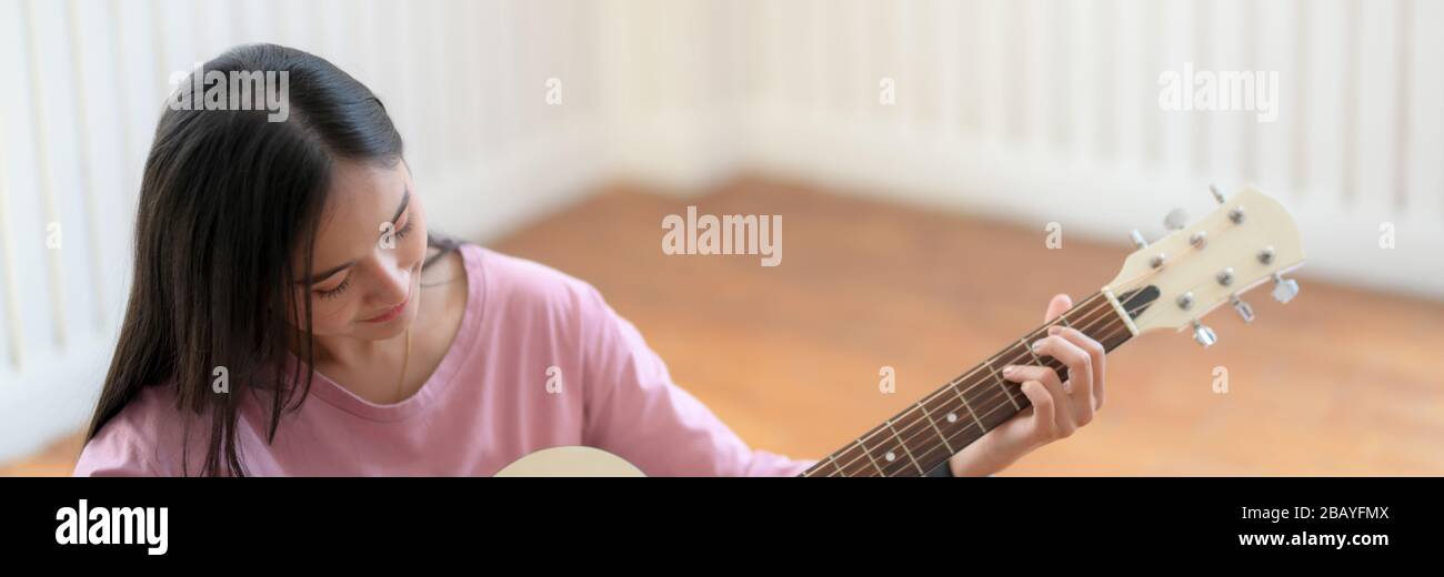 Cropped shot of young female music college student practicing guitar ...