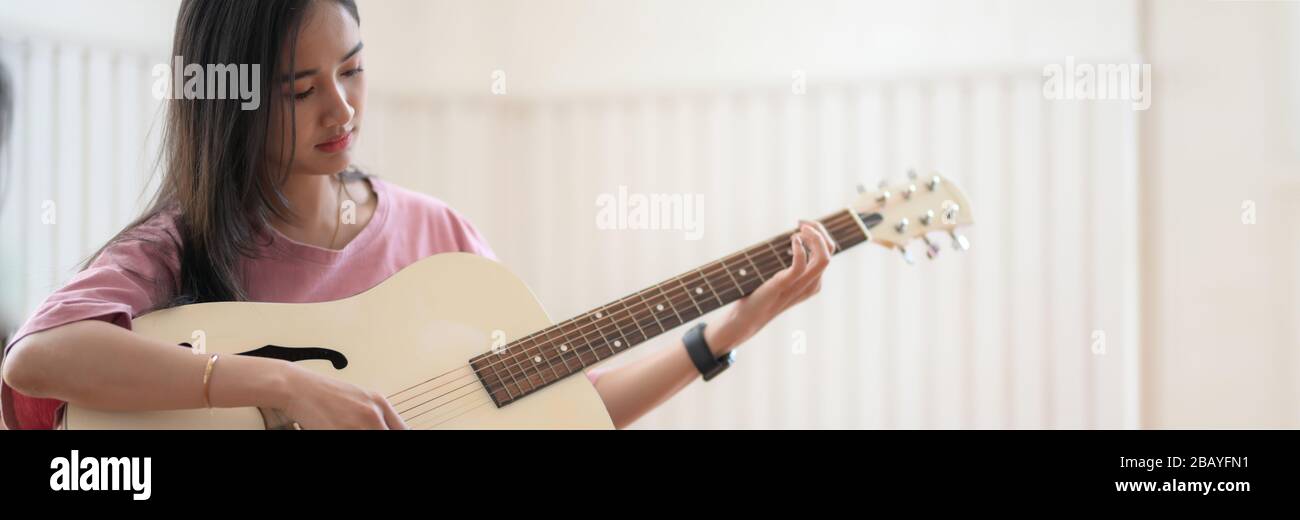 Student playing guitar in room hi-res stock photography and images - Alamy