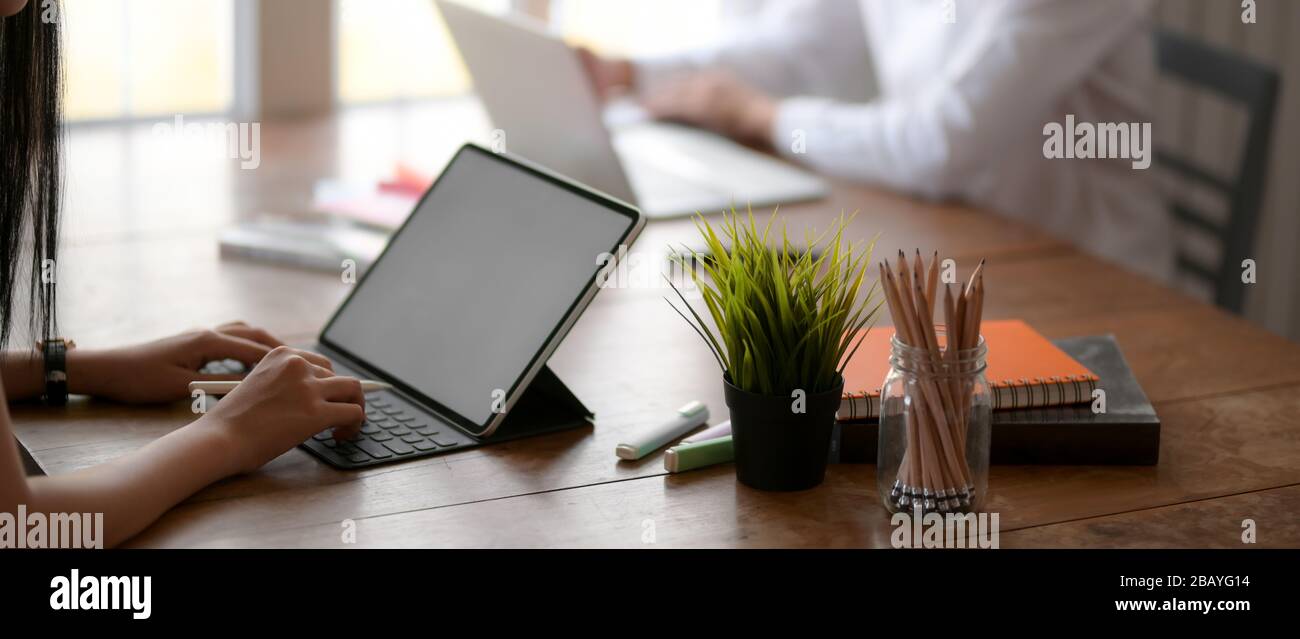 Side view of two young university students concentrating on their ...
