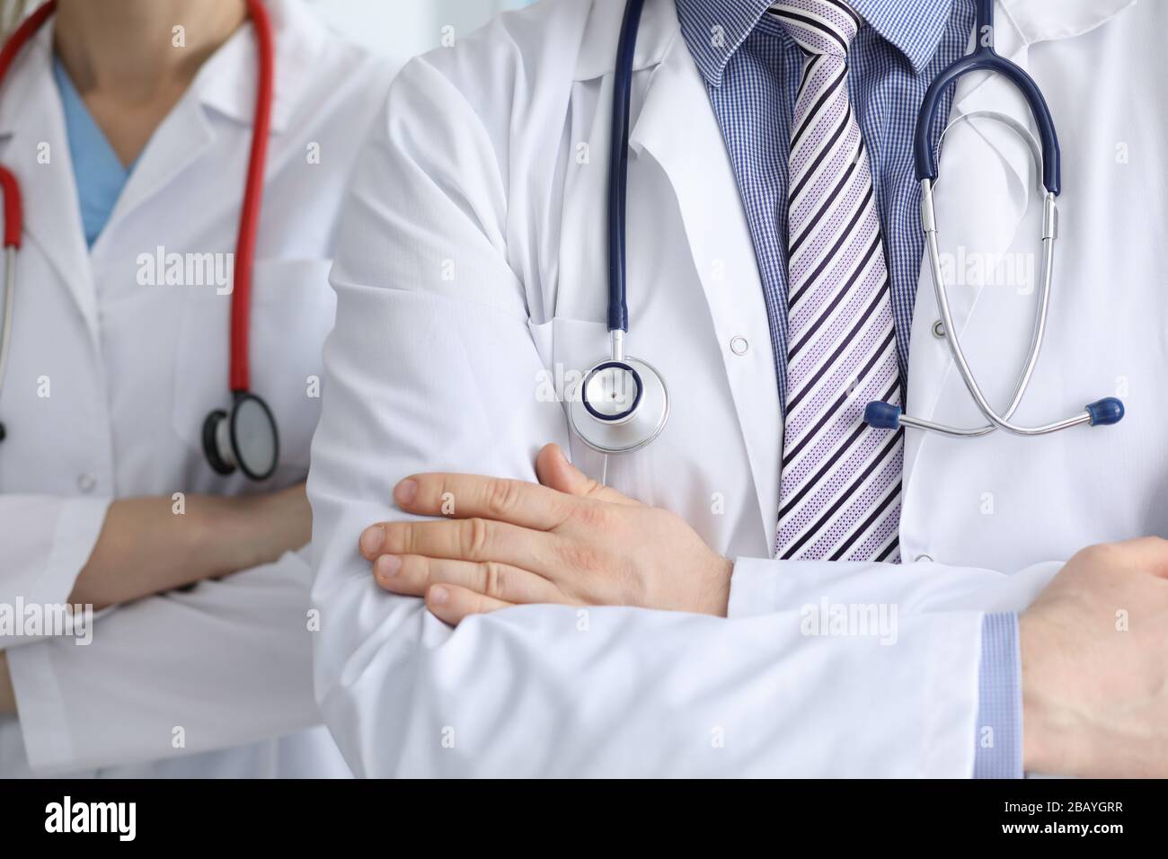 Doctors man and woman crossed arms over chest Stock Photo - Alamy