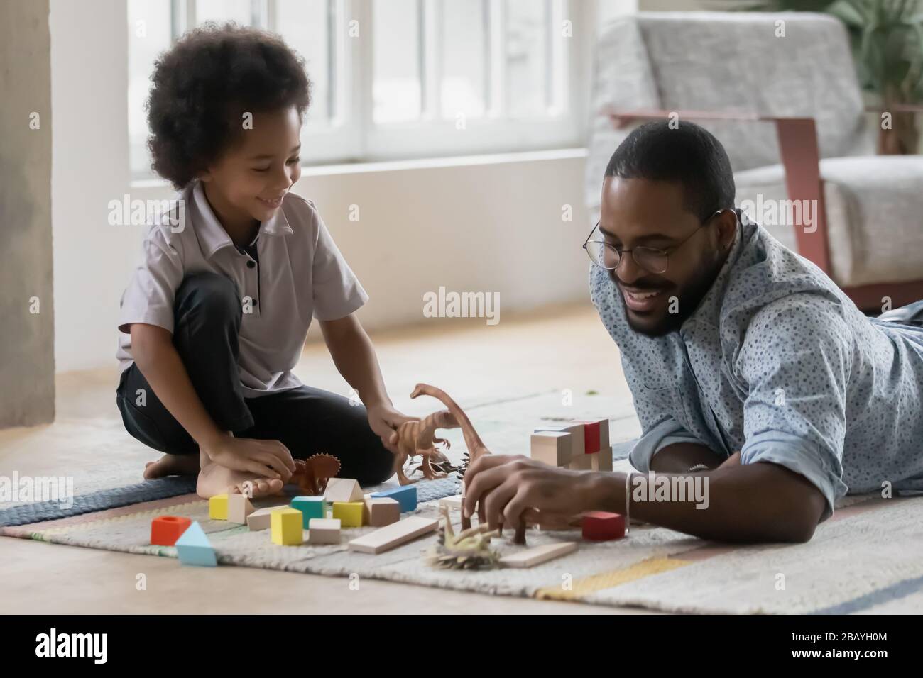 African father play with son on warm floor at home Stock Photo - Alamy