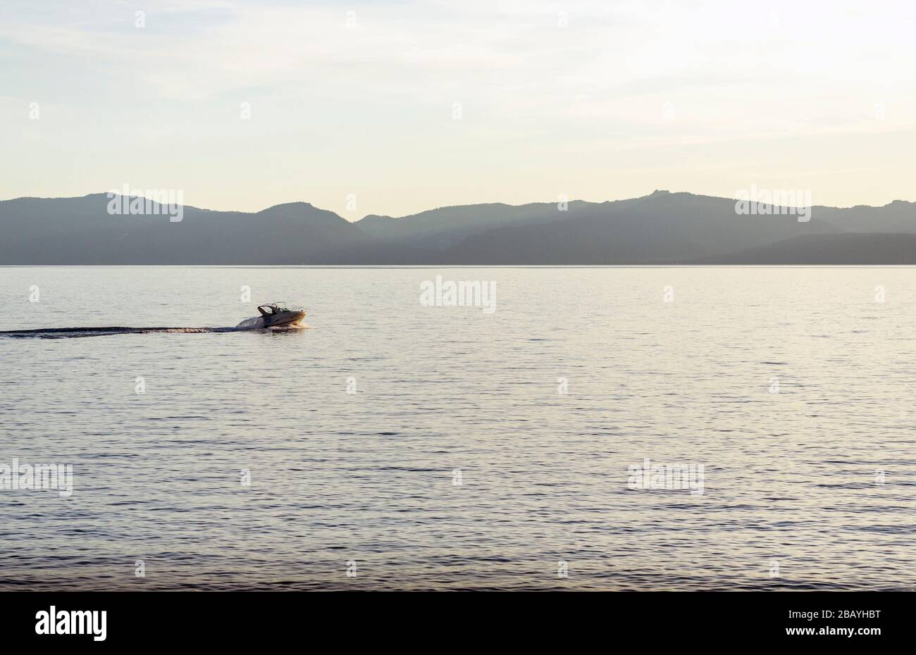 Speed boat making waves at sunset in Lake Tahoe Stock Photo - Alamy