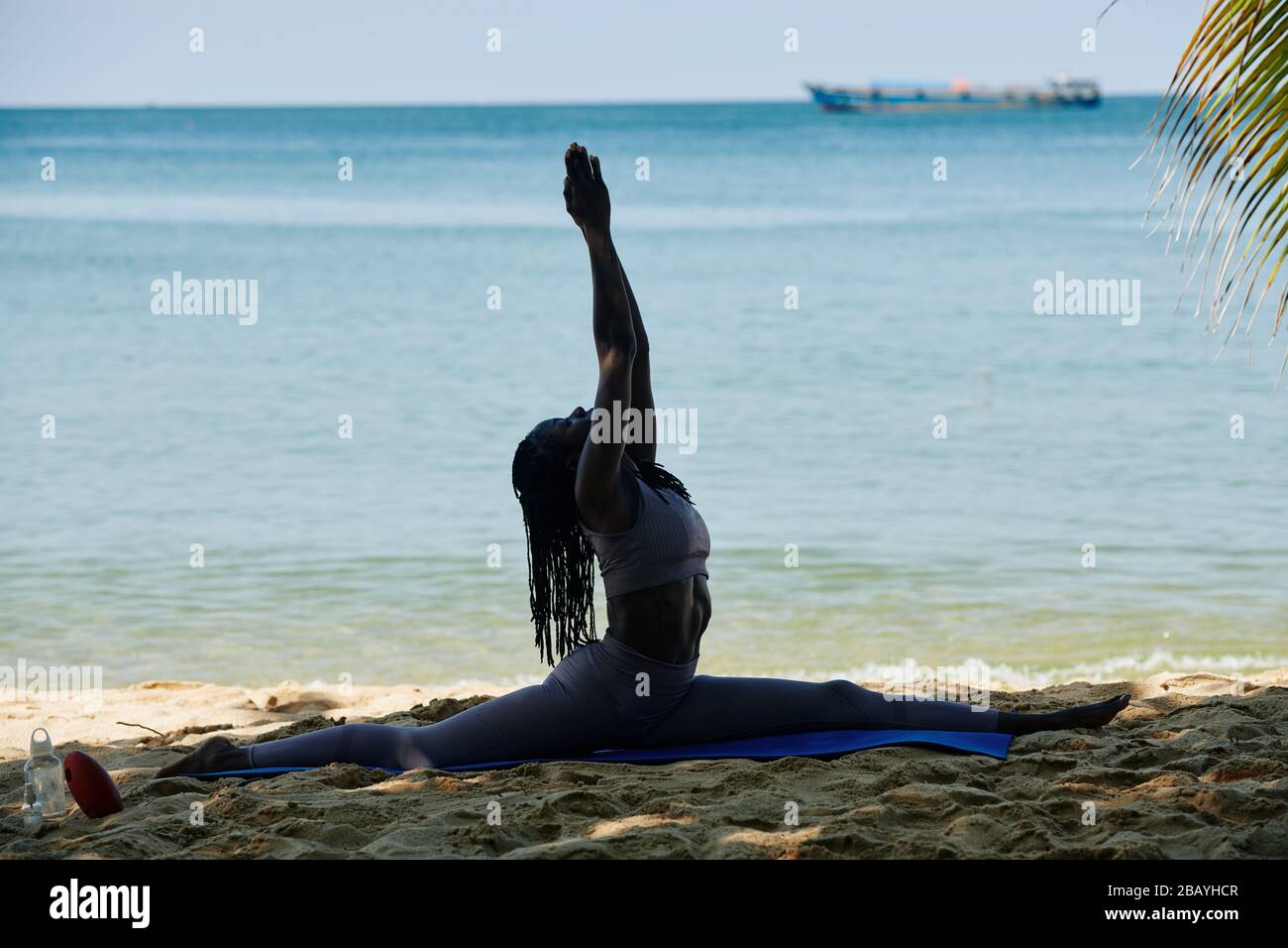 Flexible Woman Doing Splits Arching Back And Raising Arms Up In The