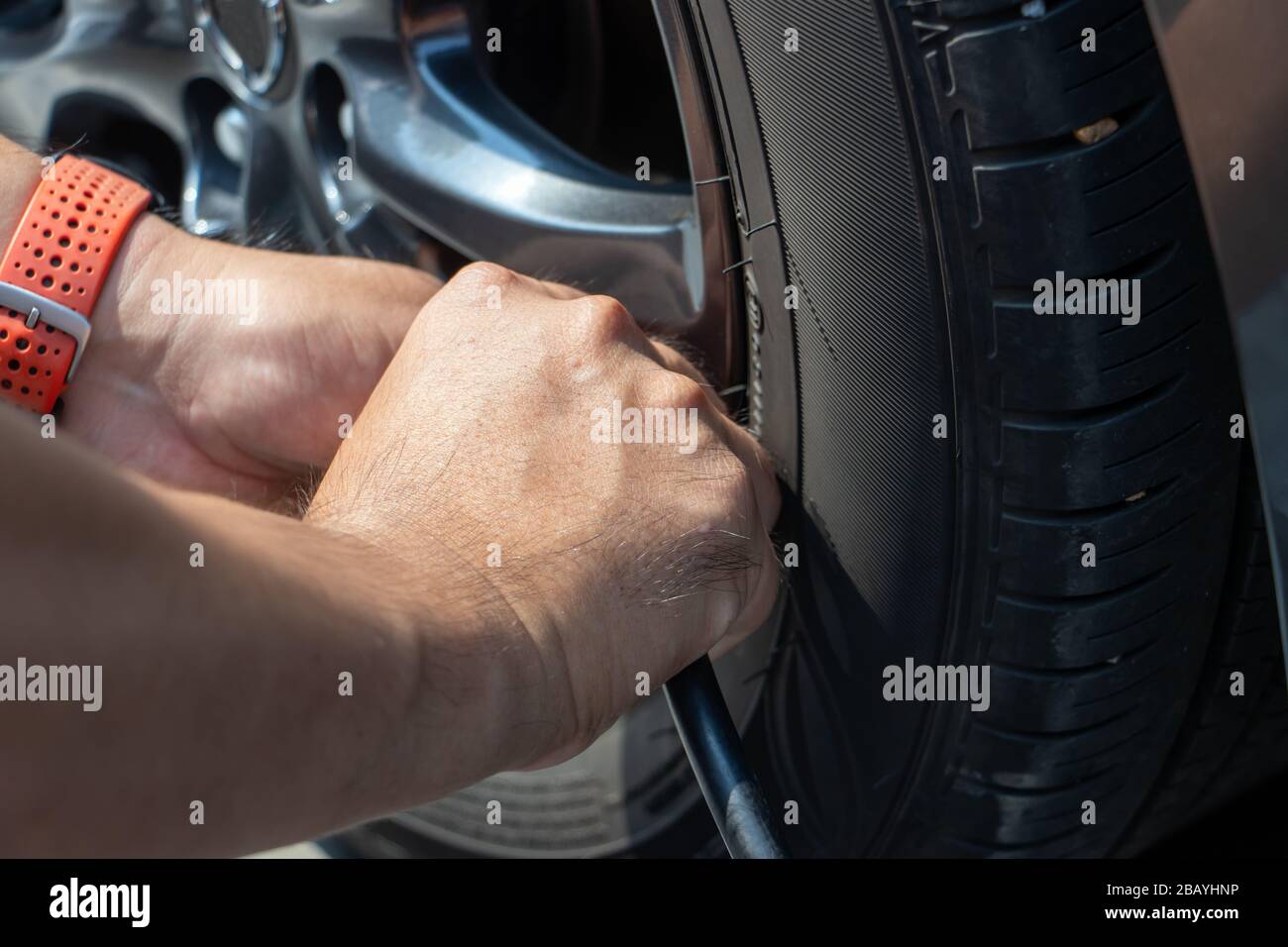 Inflating of car tires, closeup view of hands. A car service Stock ...