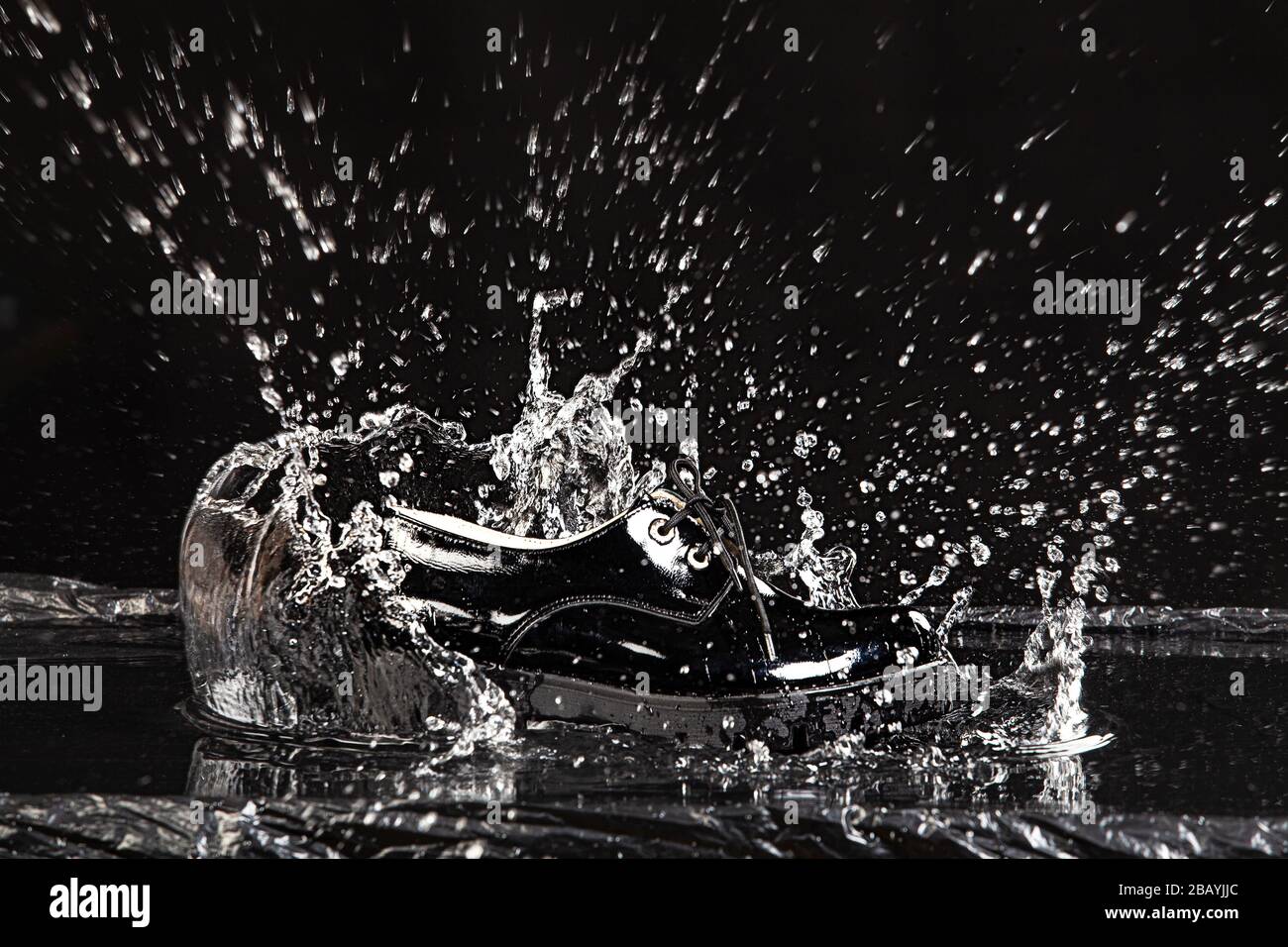 Shoe falling into the water on a studio background Stock Photo - Alamy