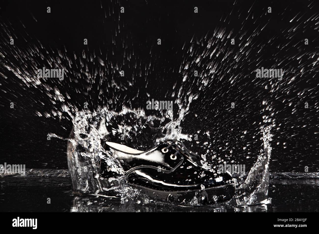Shoe falling into the water on a studio background Stock Photo - Alamy