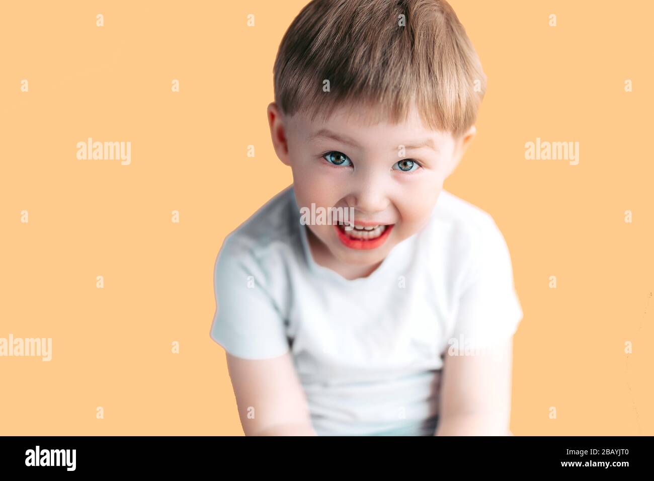 Portrait of little boy screaming with opened mouth and crazy expression ...