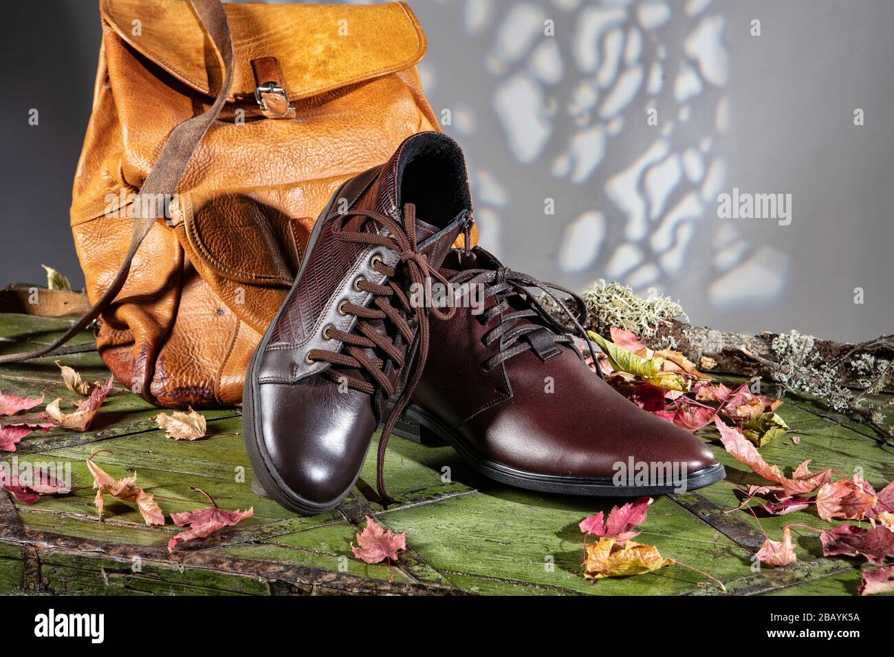 Different shoes on a wooden studio background Stock Photo - Alamy