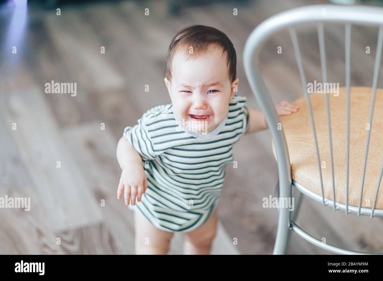 Crying little cutie drk-haired girl, stands crying loudly, standing ...