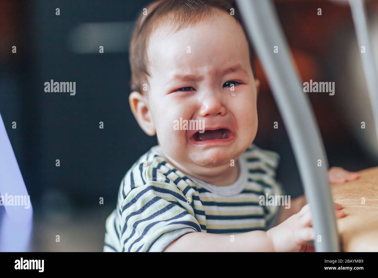 Crying little cutie drk-haired girl, stands crying loudly, standing ...