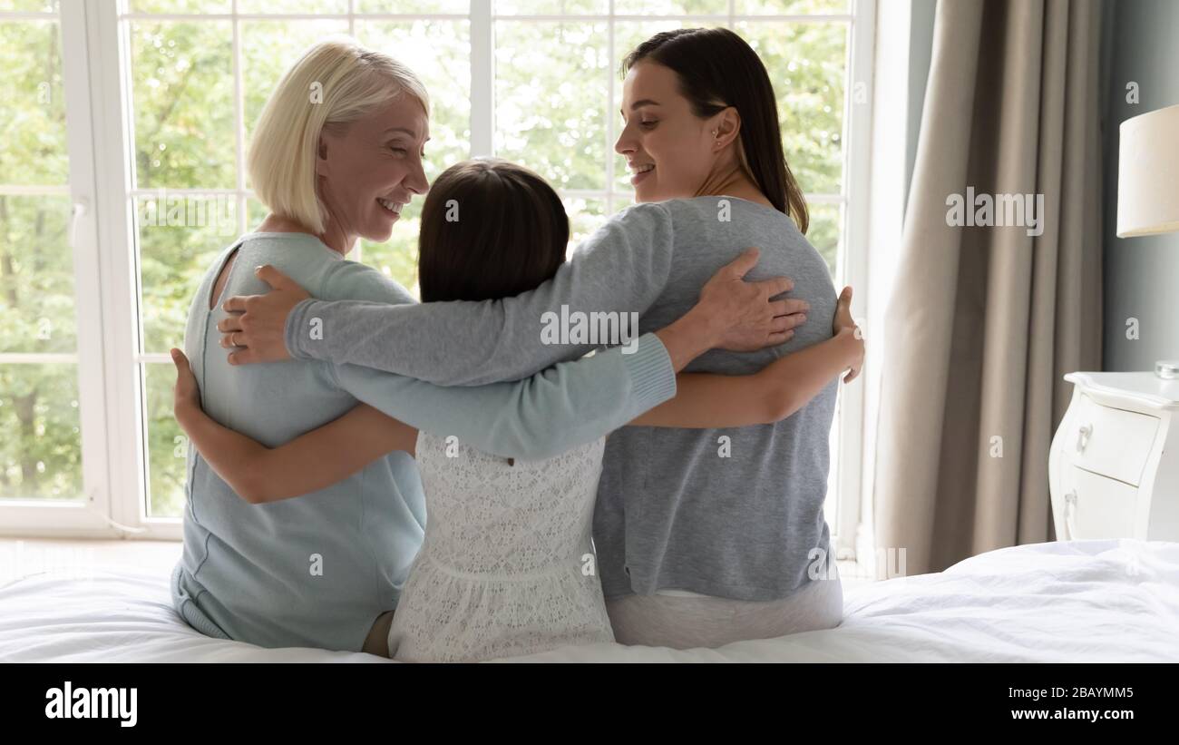 Three generations of women hug showing family unity Stock Photo - Alamy
