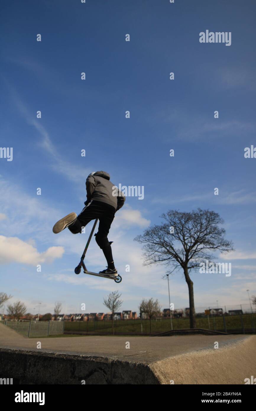 Youth scooter rider, england, uk, skate, skatepark, ramps, tricks ...