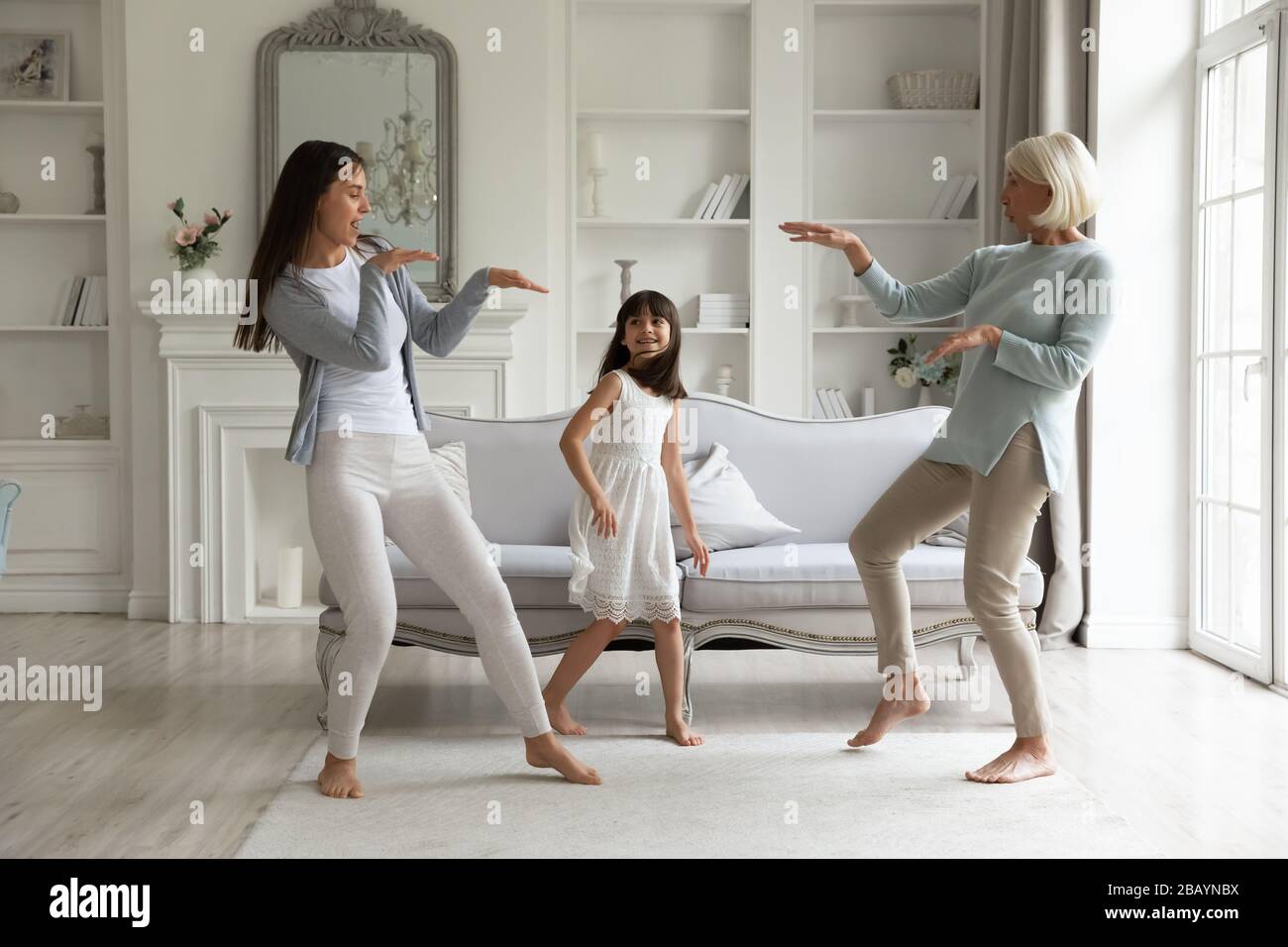 Happy three generations of women dancing together Stock Photo - Alamy