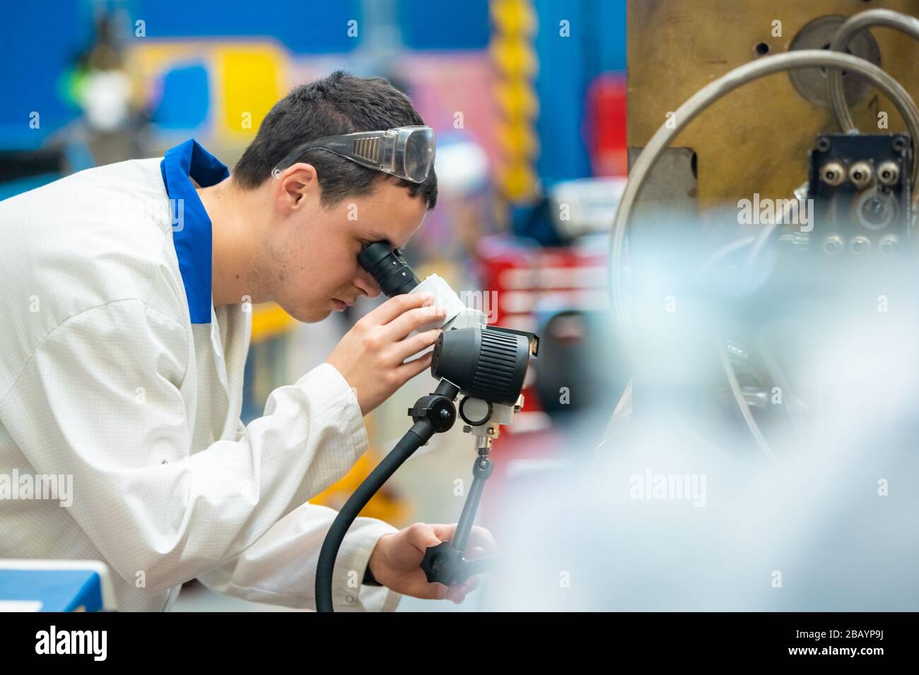 smooth accurate work in the factory under microscope Stock Photo - Alamy