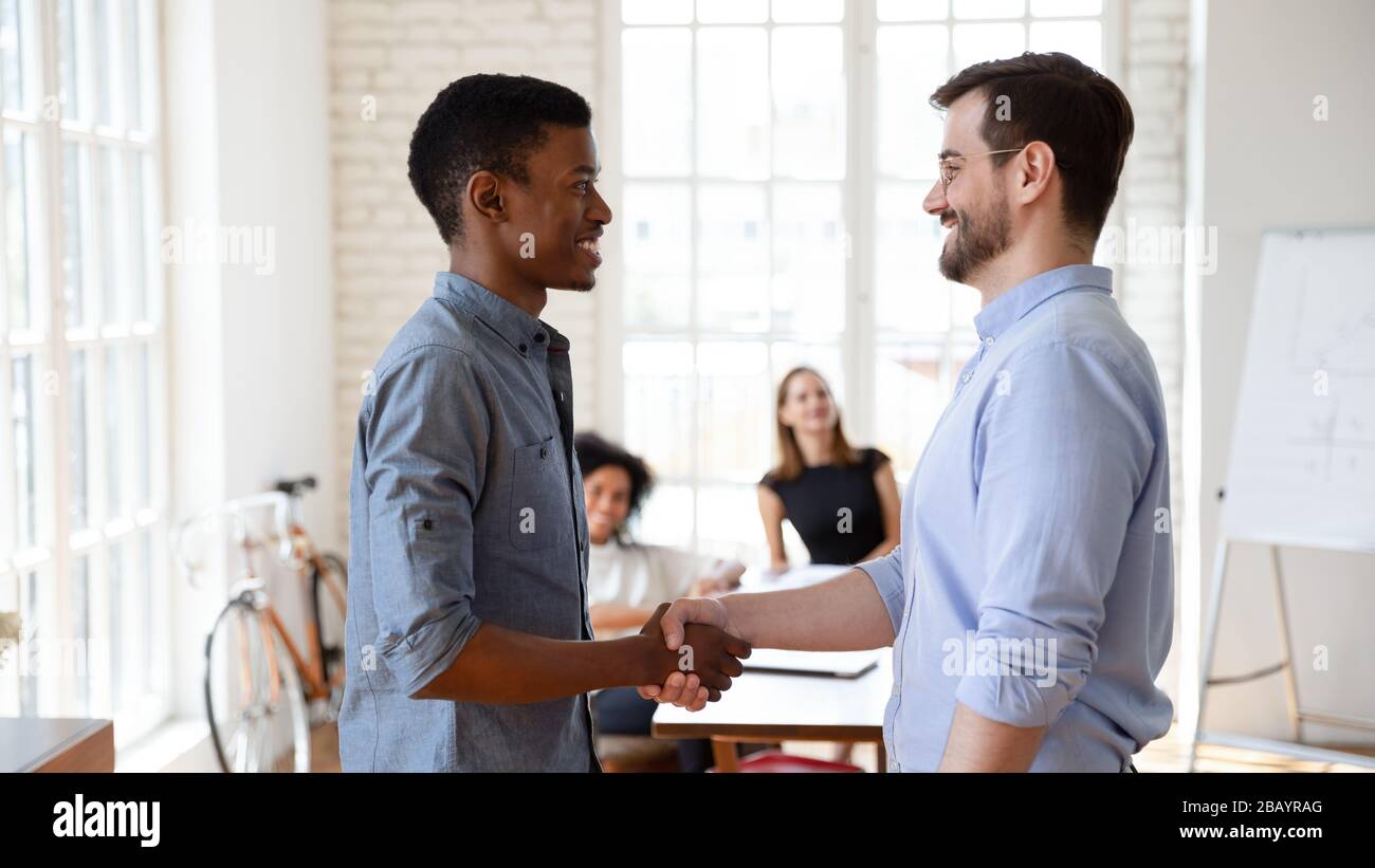 Boss handshake employee praising him express gratitude for outstanding ...