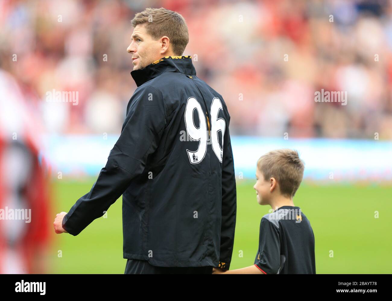 Liverpool's Steven Gerrard walks out with Justice 96 on the back of his ...