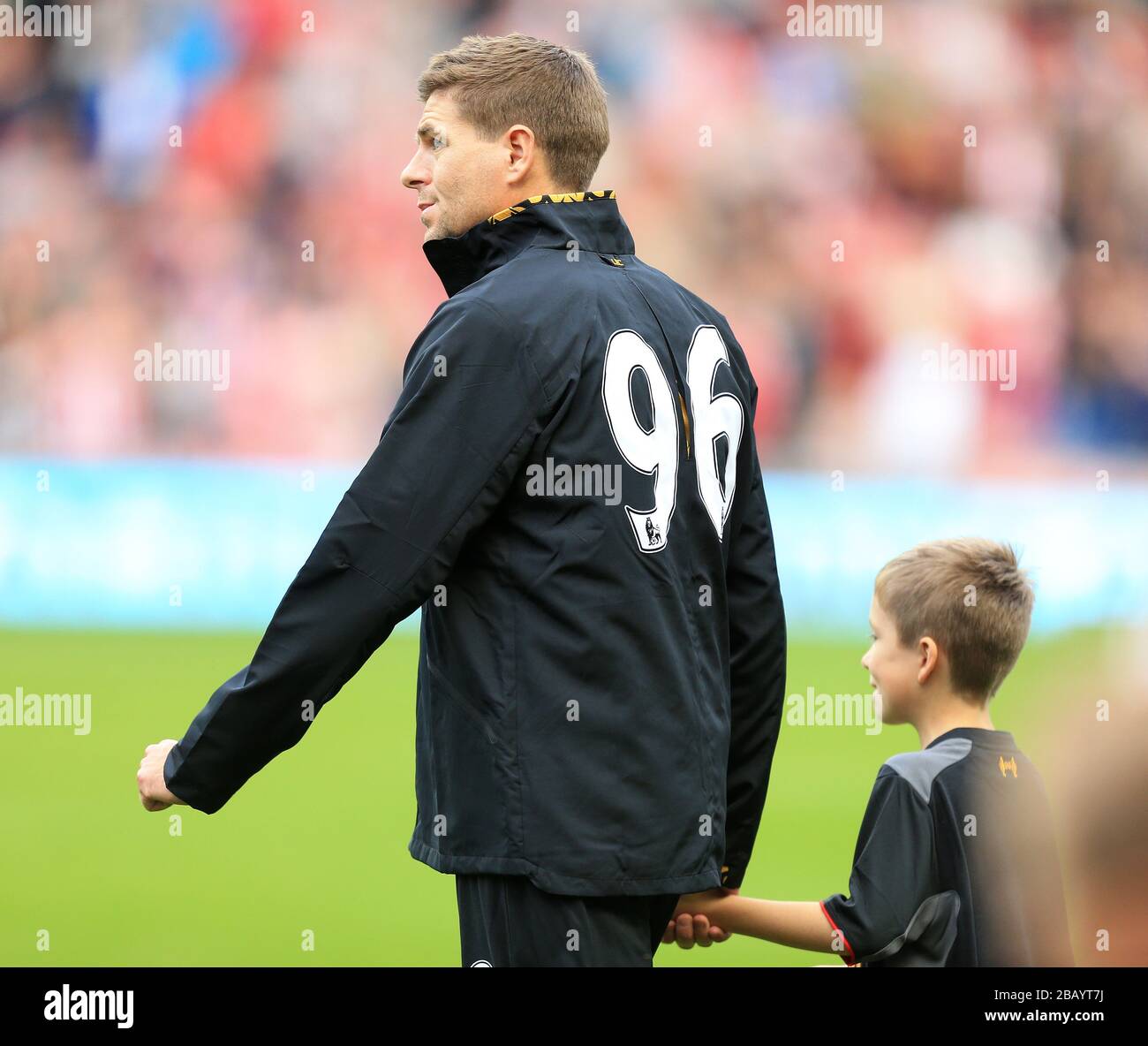 Liverpool's Steven Gerrard walks out with Justice 96 on the back of his ...